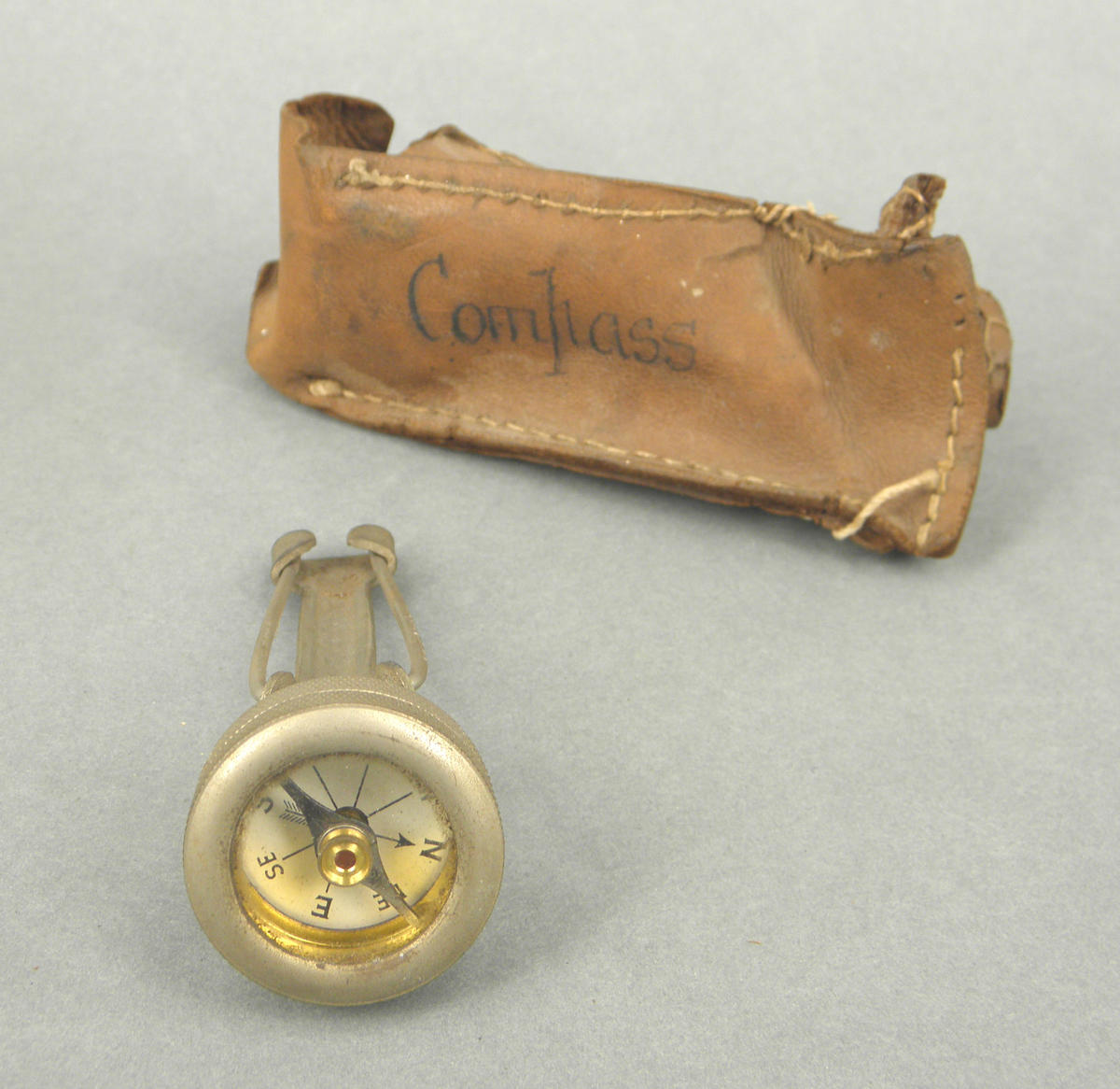 Compass in leather holder - Te Awamutu Museum